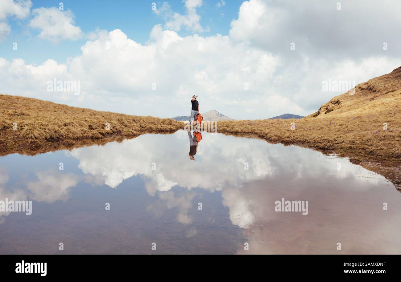 Hiker drinking water from bottle, hiking hydration Stock Photo - Alamy