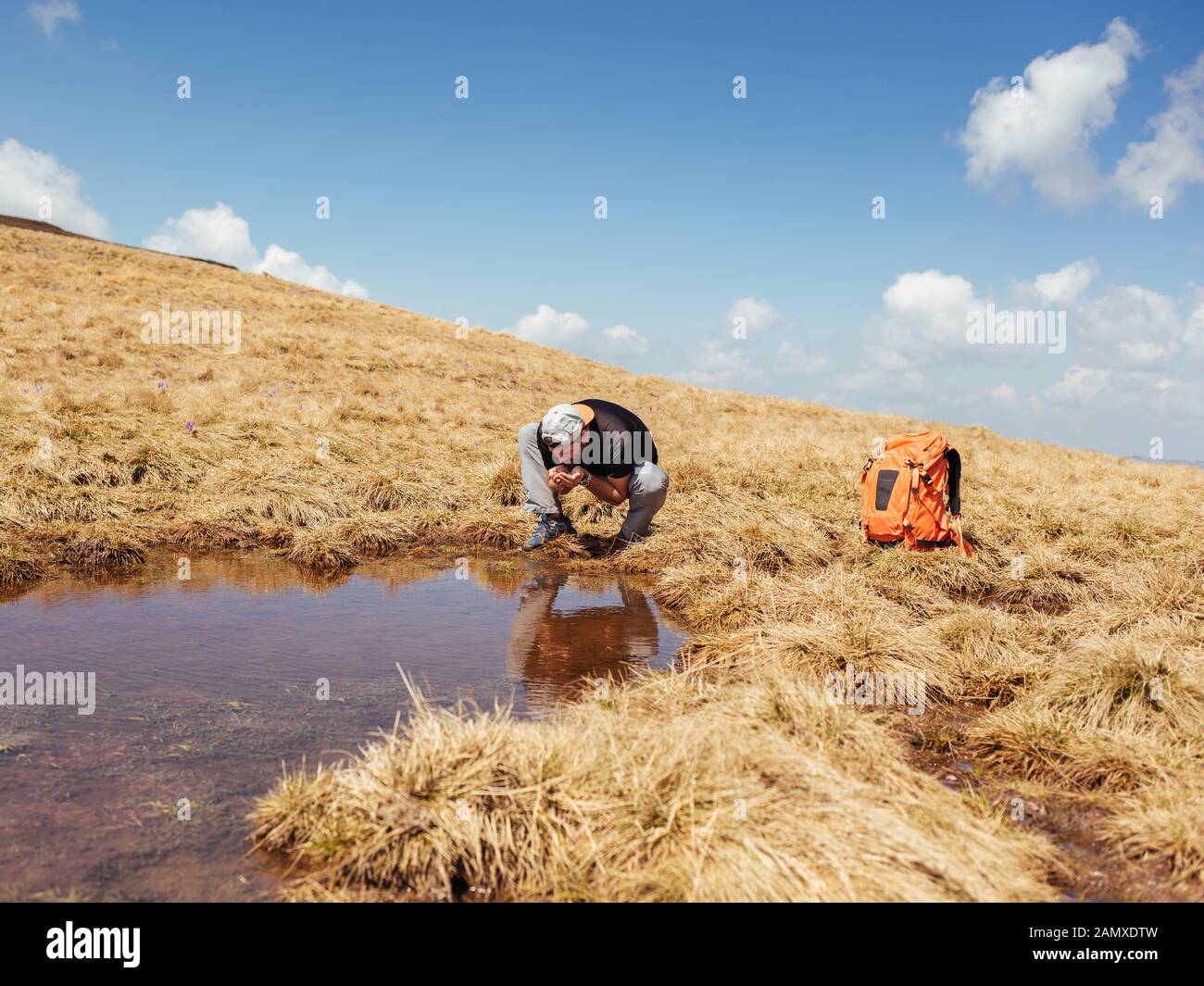 Hiker drinking water from bottle, hiking hydration Stock Photo - Alamy