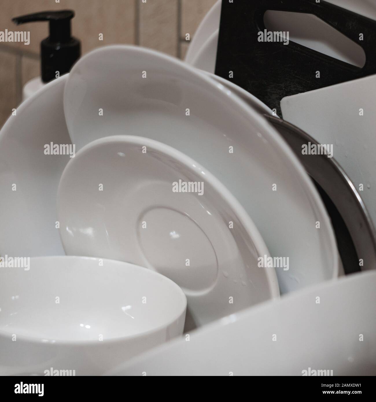 Bunch of just washed dishes piled upon a drier in a square Stock Photo ...
