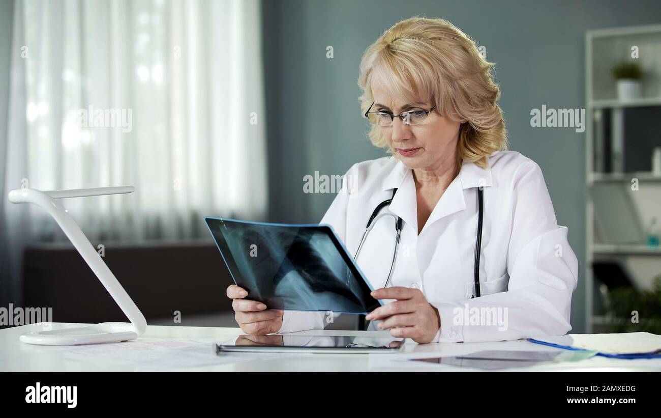 Doctor looking at scan, examining X-ray of patient lungs, health care ...