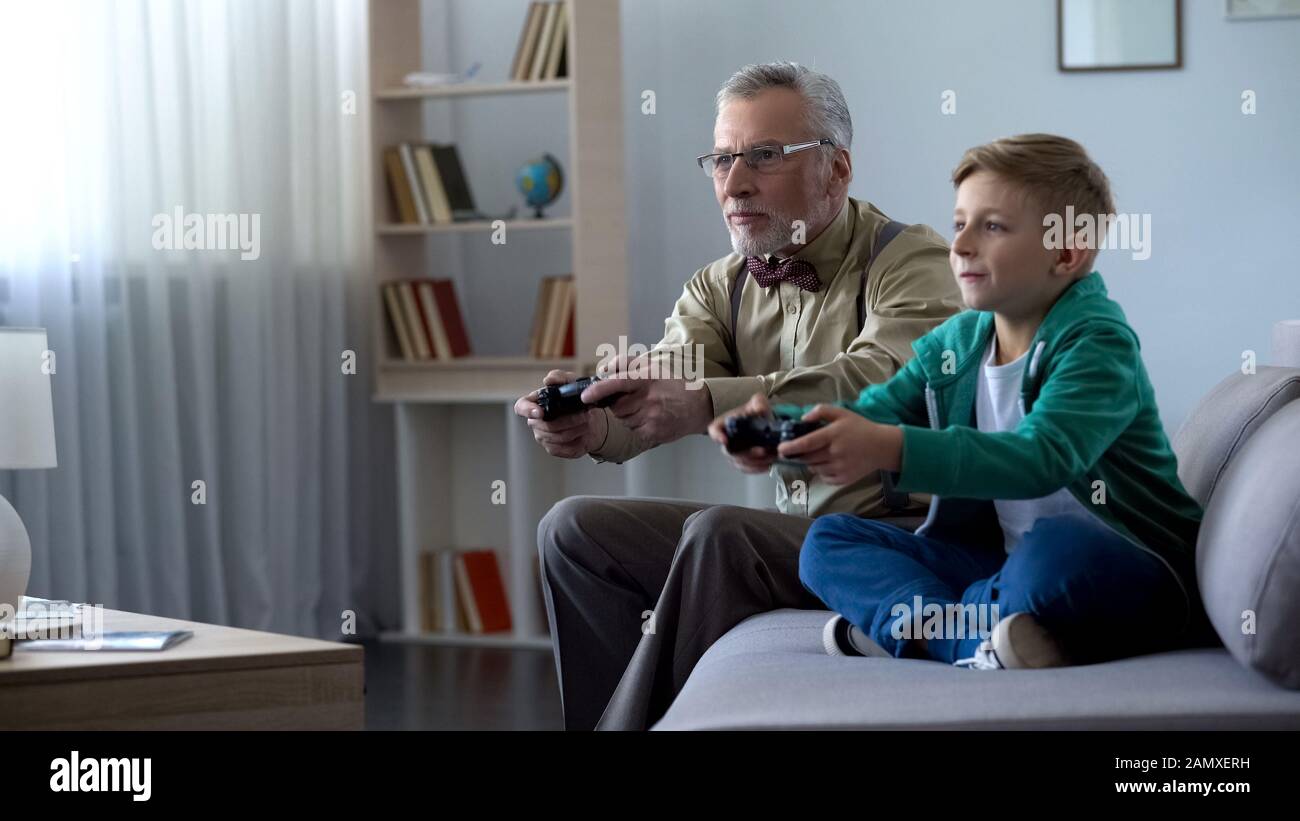 Grandpa and grandson playing video game with console, happy time ...