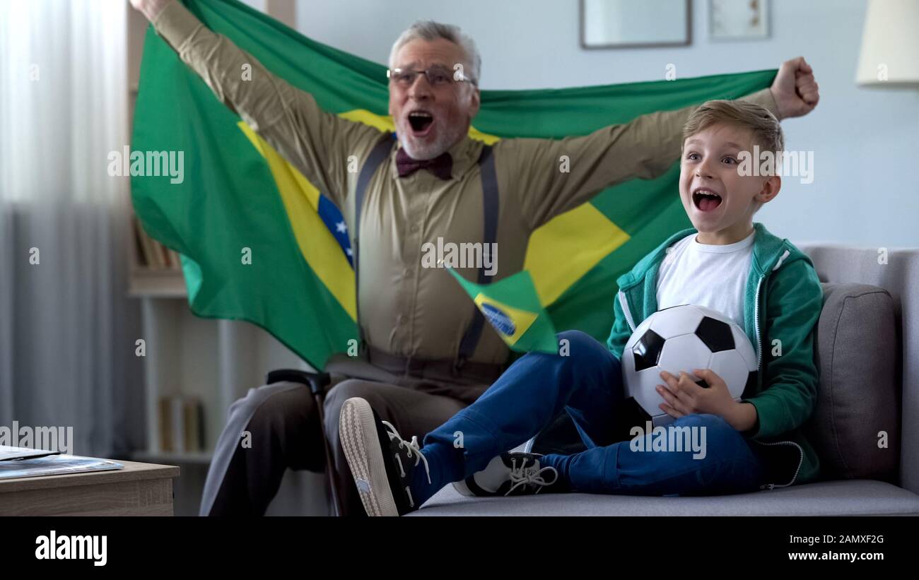Grandpa waving Brazil flag, together with boy celebrate victory of ...