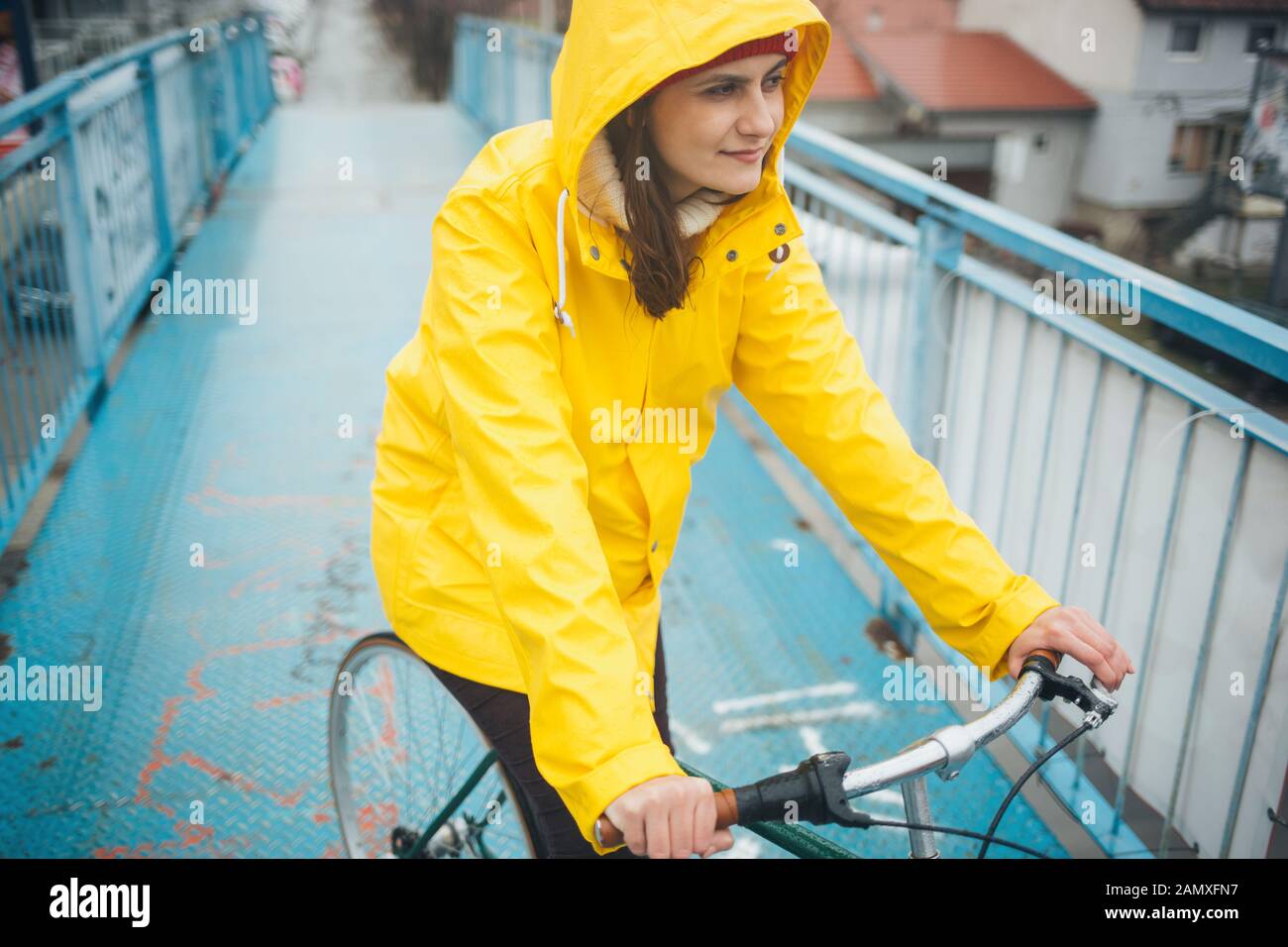 Girl riding bike rain hi-res stock photography and images - Alamy
