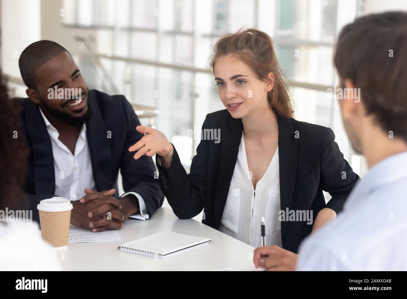 Female employee talk discussing ideas with colleagues at meeting Stock ...