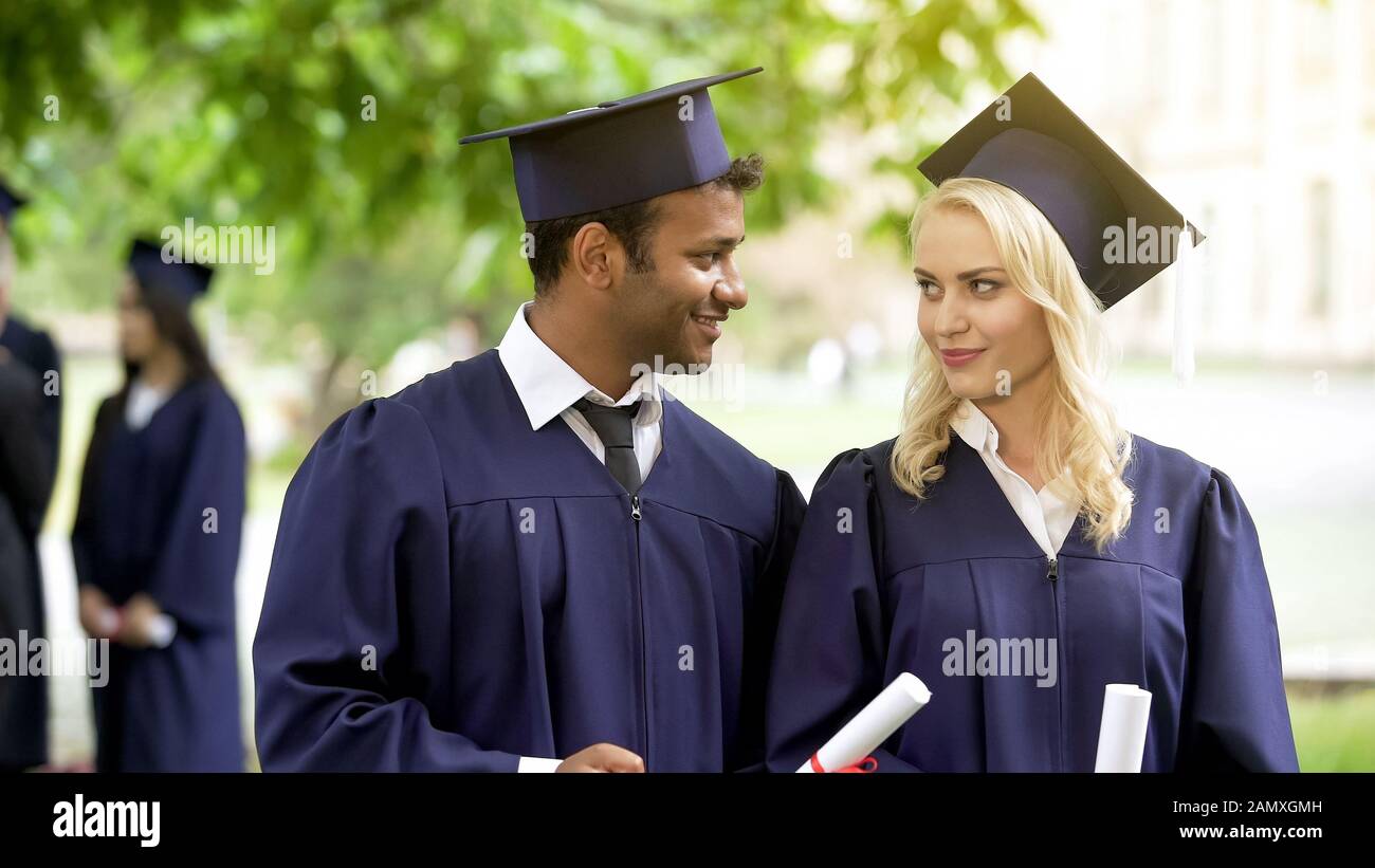 Graduate students confidently watching to each other, best friends ...