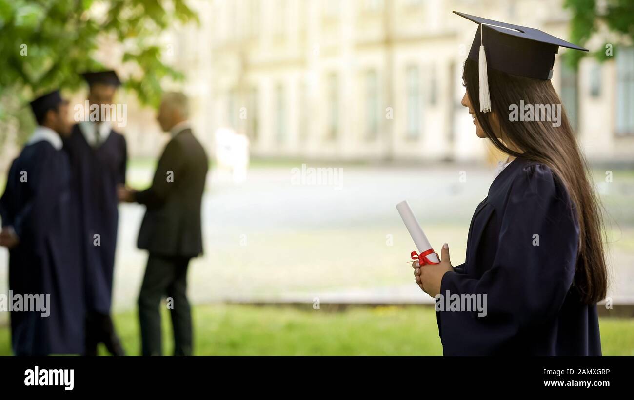 College female graduate celebrating successful completion of education ...