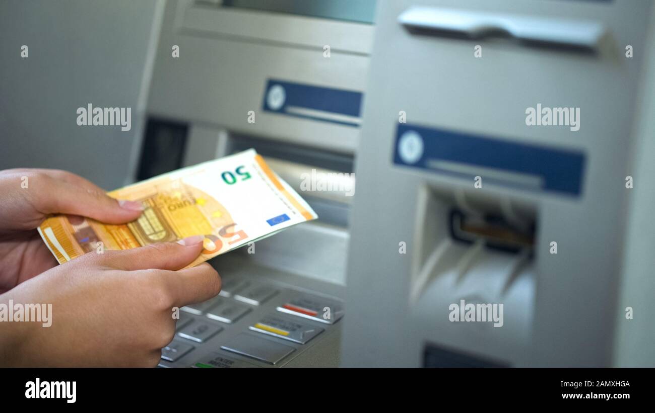 Woman getting euros from automatic teller machine, cash withdrawing ...