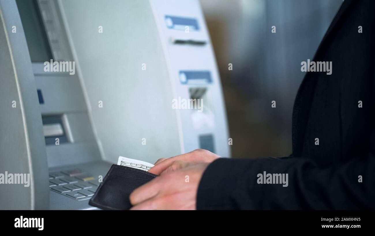 Putting money in purse hi-res stock photography and images - Alamy