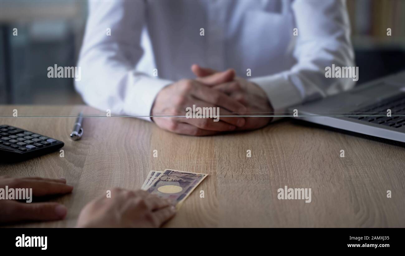 Customer giving bank clerk japanese yen, currency transaction, exchange ...