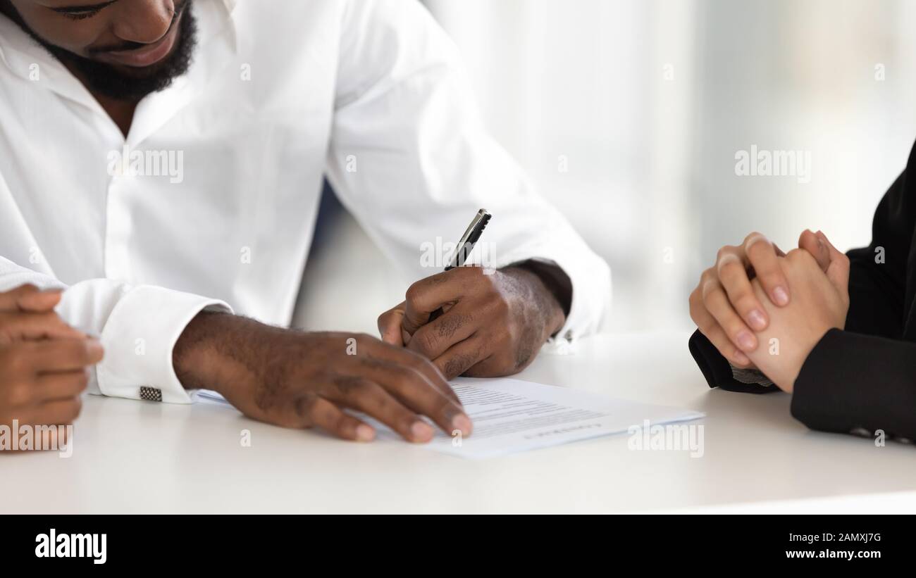 African American male client sign contract closing deal Stock Photo - Alamy