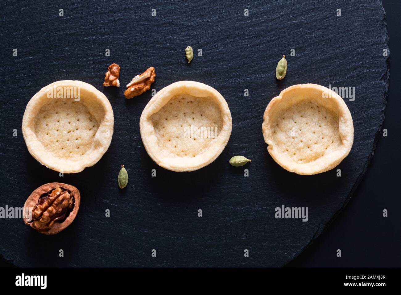 Food concept Empty, blank homemade organic tarts, pie shell on black ...