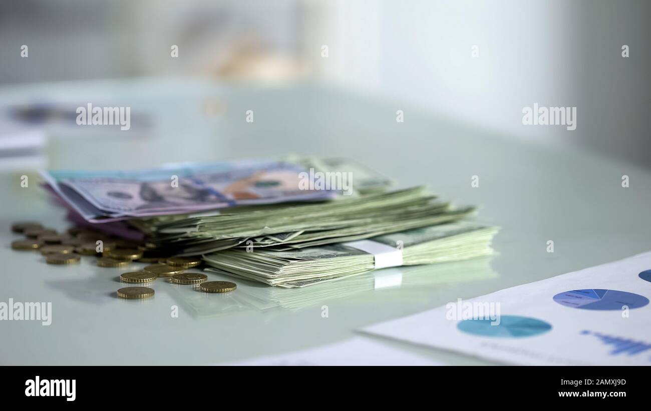Stacks of dollar banknotes and coins on table, deposit, salary earnings ...