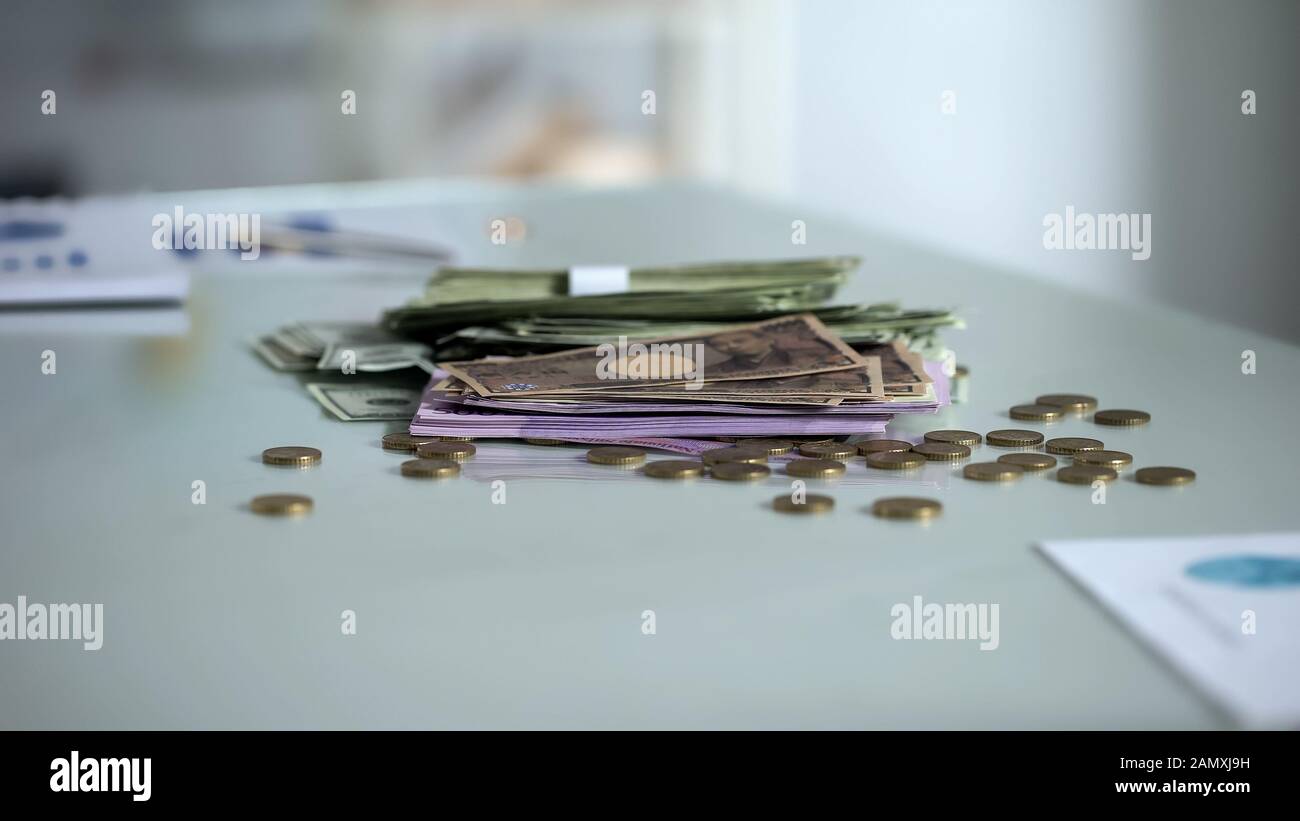 Stacks of banknotes and coins on table, foreign currency, salary ...