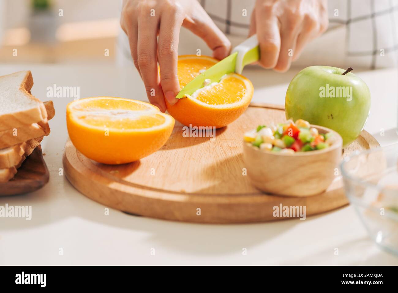 Cutting orange hi-res stock photography and images - Alamy