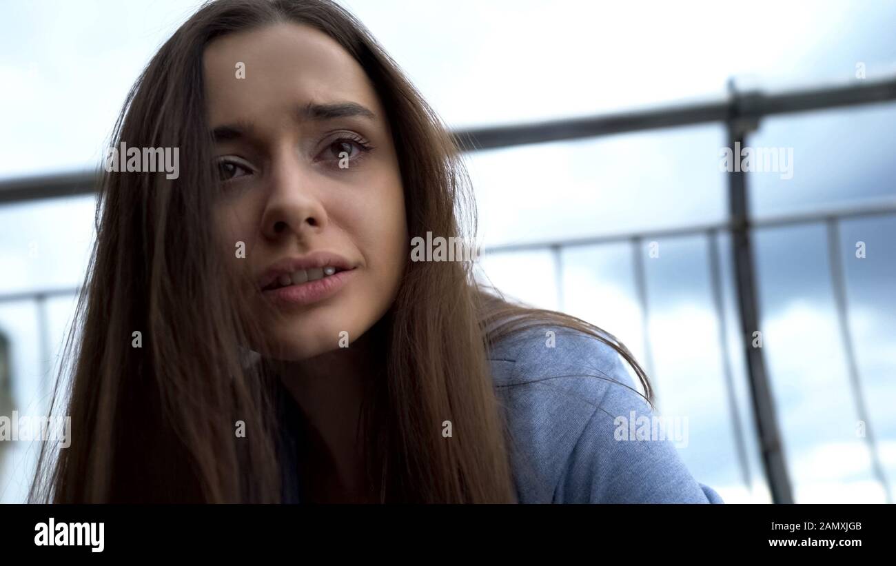 Worried woman looking with hope into camera, domestic violence ...
