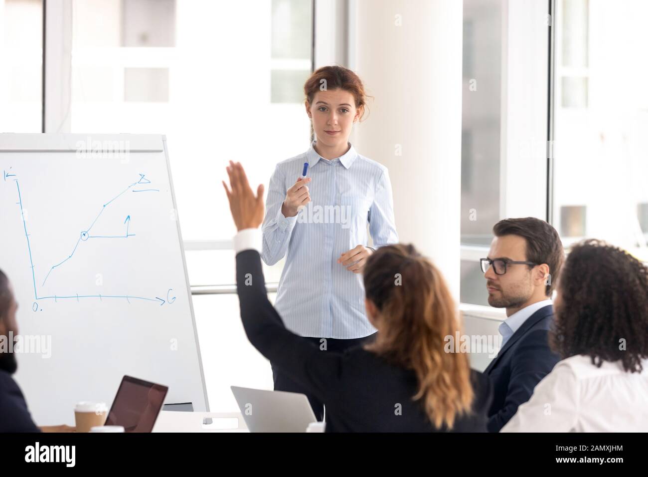 Female coach interact with employees at work office training Stock ...