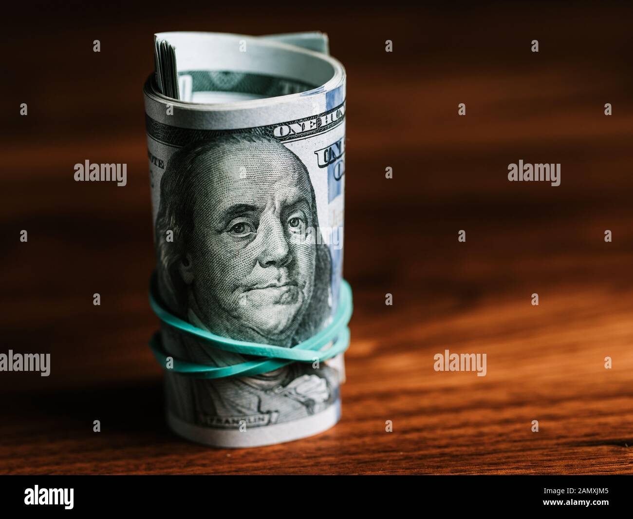 One hundred dollar bills on a table. Copy space Stock Photo - Alamy