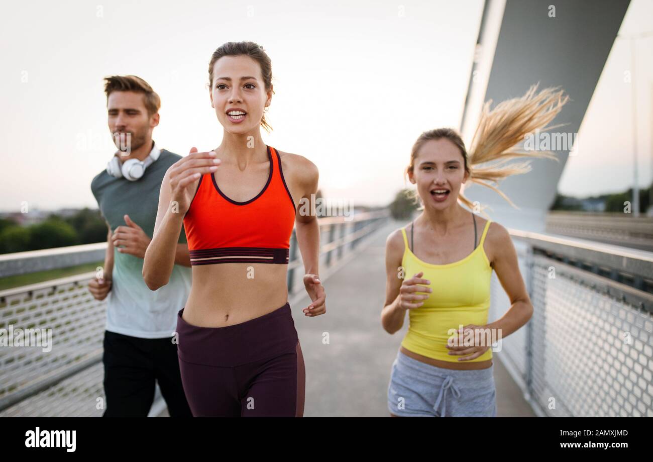 Fitness, sport, people and running concept. Happy fit friends running ...