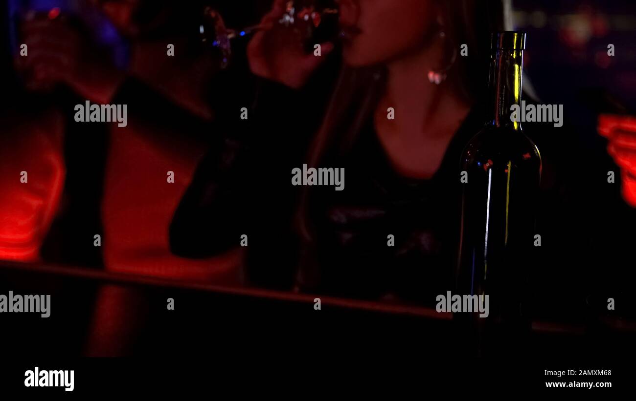 Girl drinking wine alone in nightclub, partying, female alcoholism ...