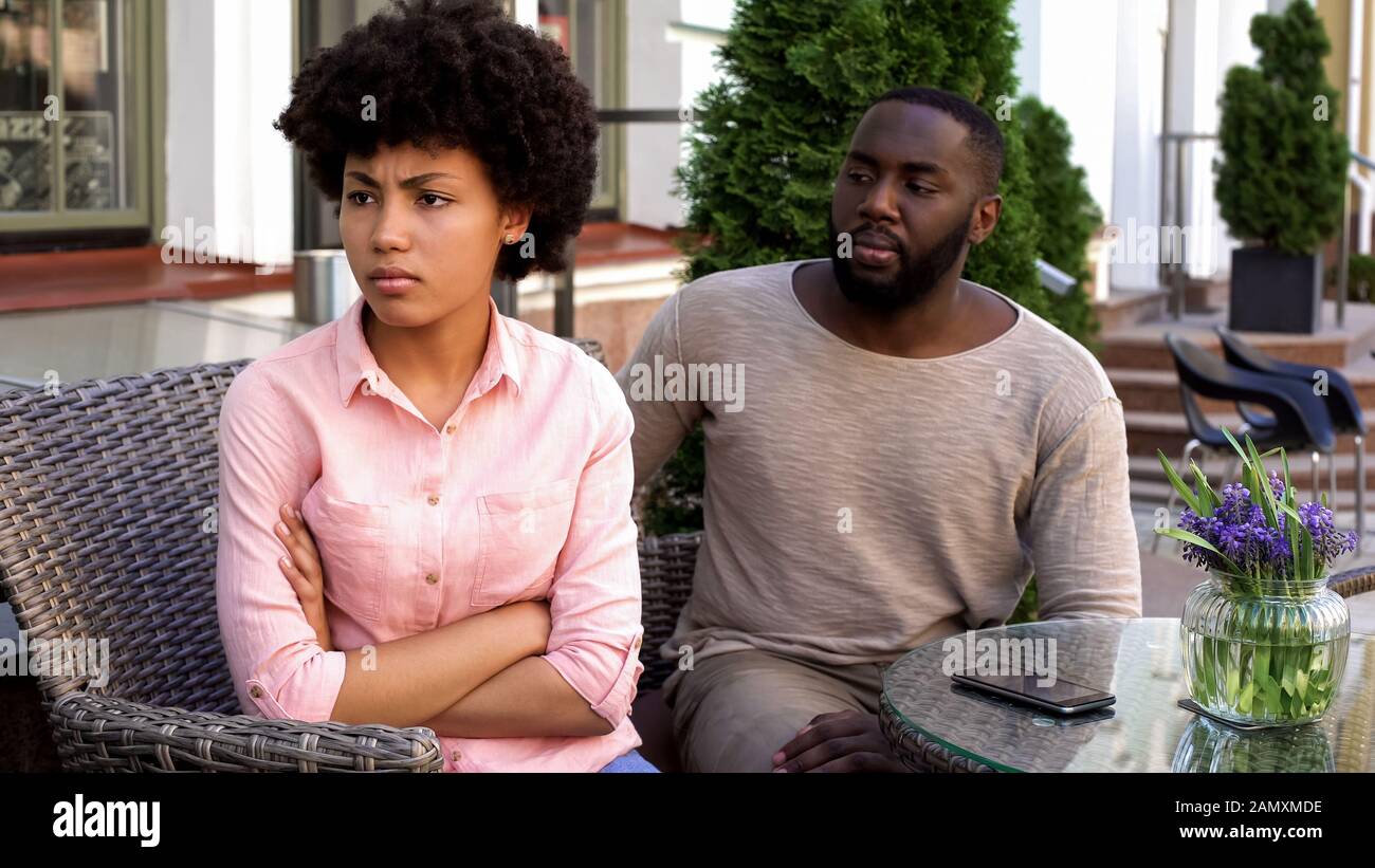 Unhappy girlfriend ignoring boyfriend, turned away, misunderstanding ...