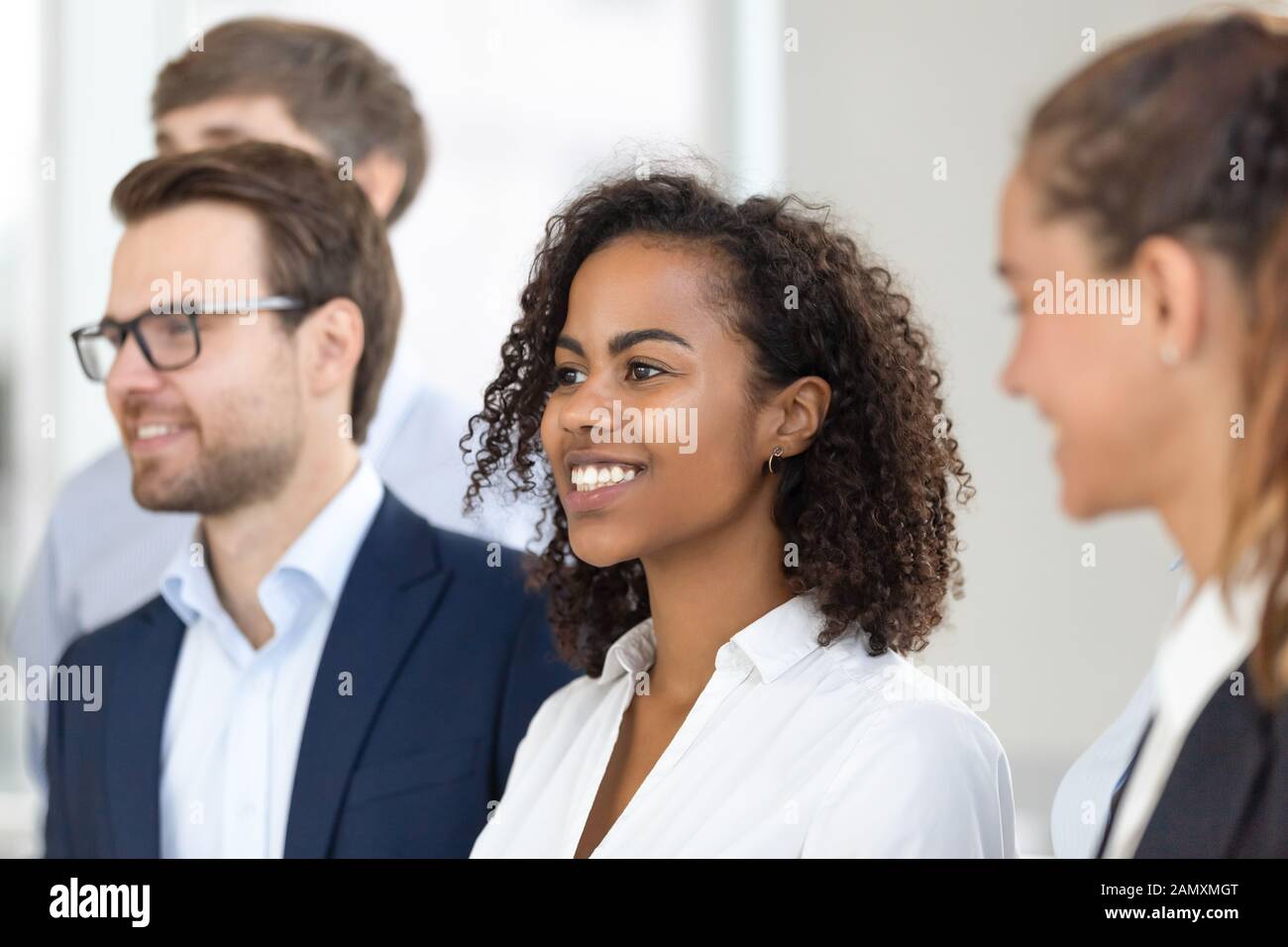 Multiethnic smiling team stand in row making group picture Stock Photo ...