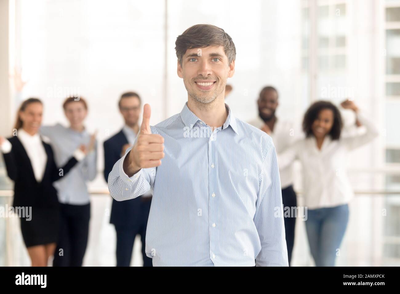 Smiling male look at camera show thumbs up recommending service Stock ...