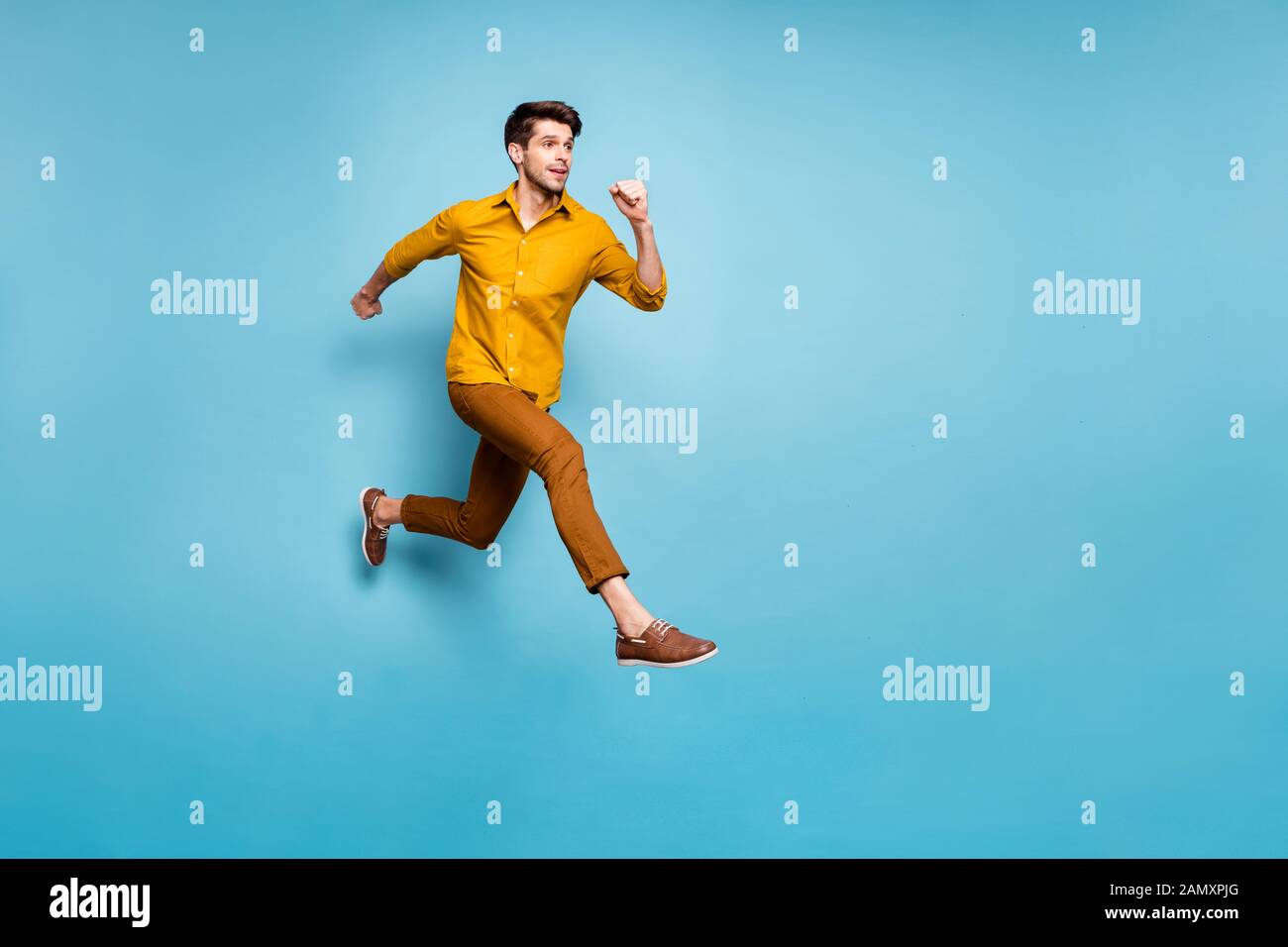 Full length profile photo of funny excited guy jumping high running ...