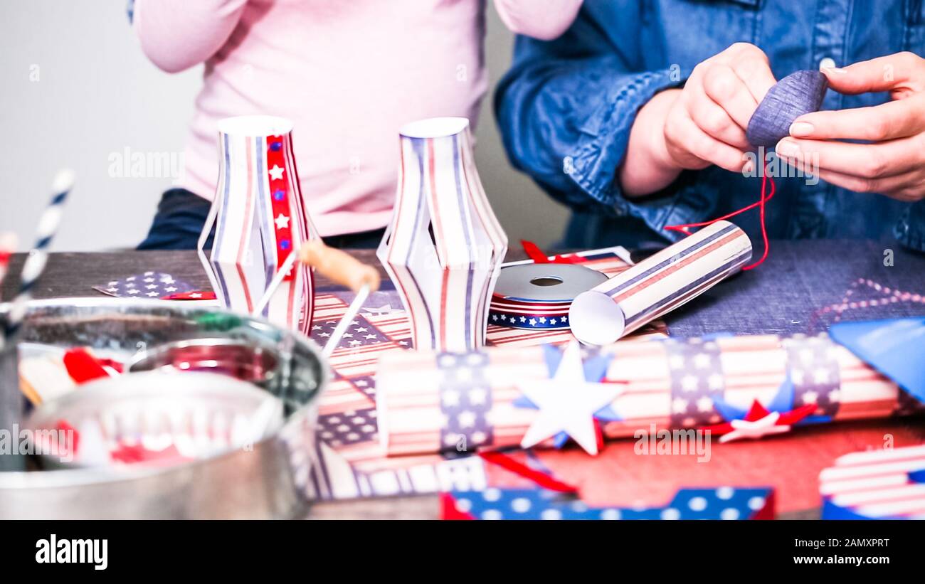 Step by step. Mother and daughter making paper firecrackers for July ...