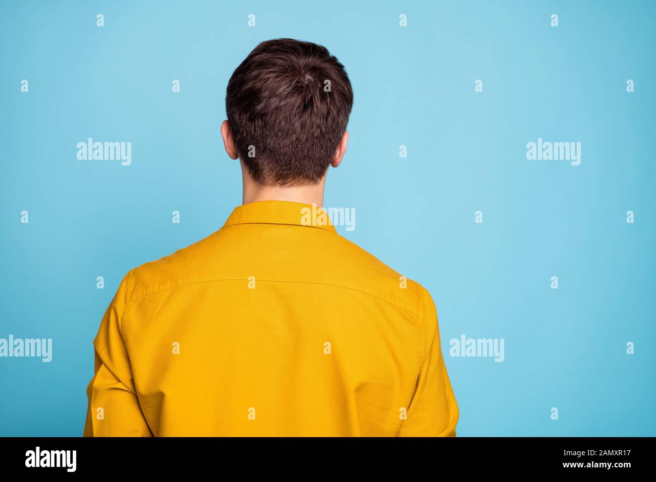 Rear behind view photo of brunette guy standing turned back not showing ...