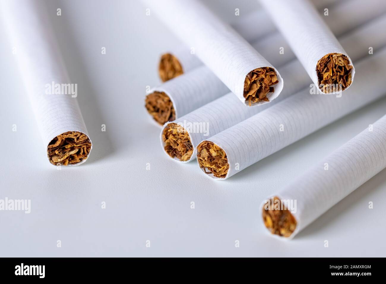 Closeup of a pile of cigarettes over white background Stock Photo - Alamy