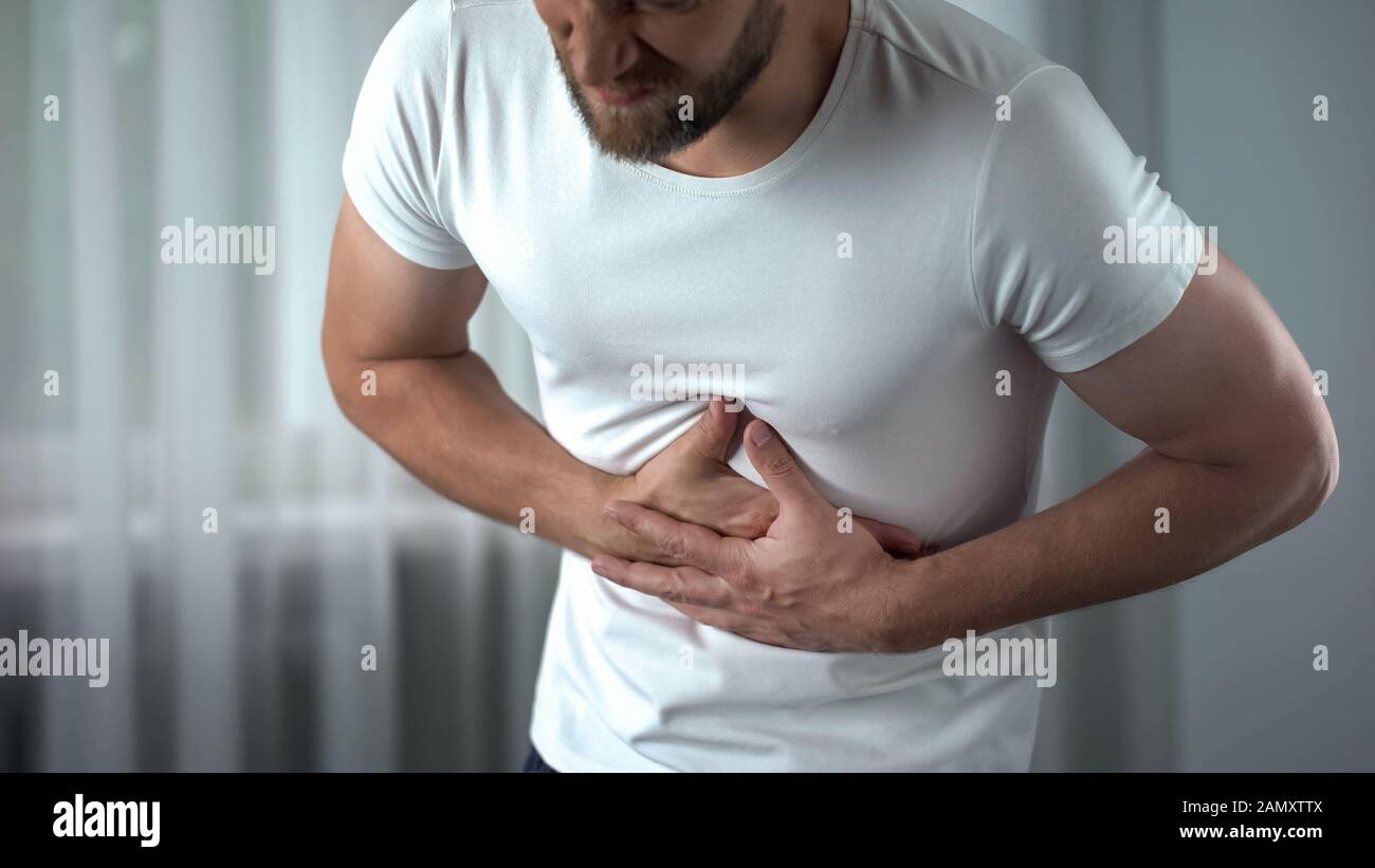 Man suffering bellyache at home, gastritis symptom, peptic ulcer ...