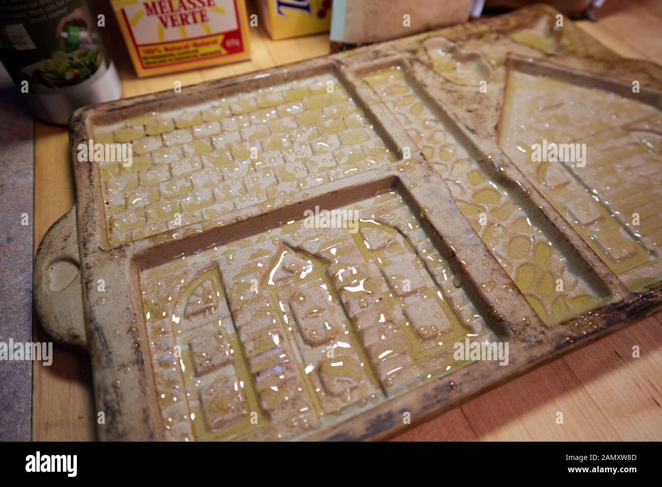oiled ceramic gingerbread house mold ready for adding dough Stock Photo ...