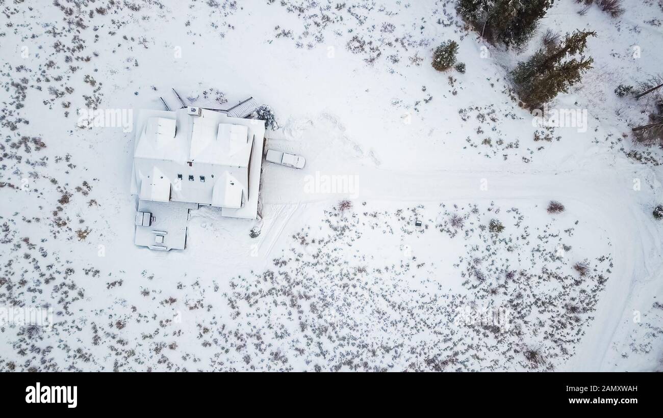 Aerial view of the mountain house covered in snow in the Winter Stock ...