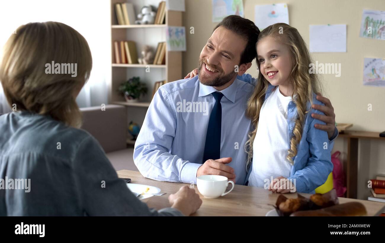 Smiling daughter and father looking at strict mother asking for day-off ...