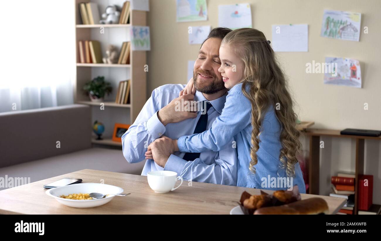 Curly haired daughter walking to father and hugging him, kids sincerity ...
