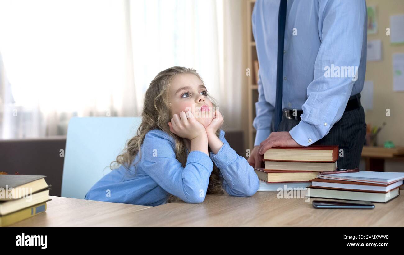 Offended little girl neglecting homework, ignoring daddys remarks ...