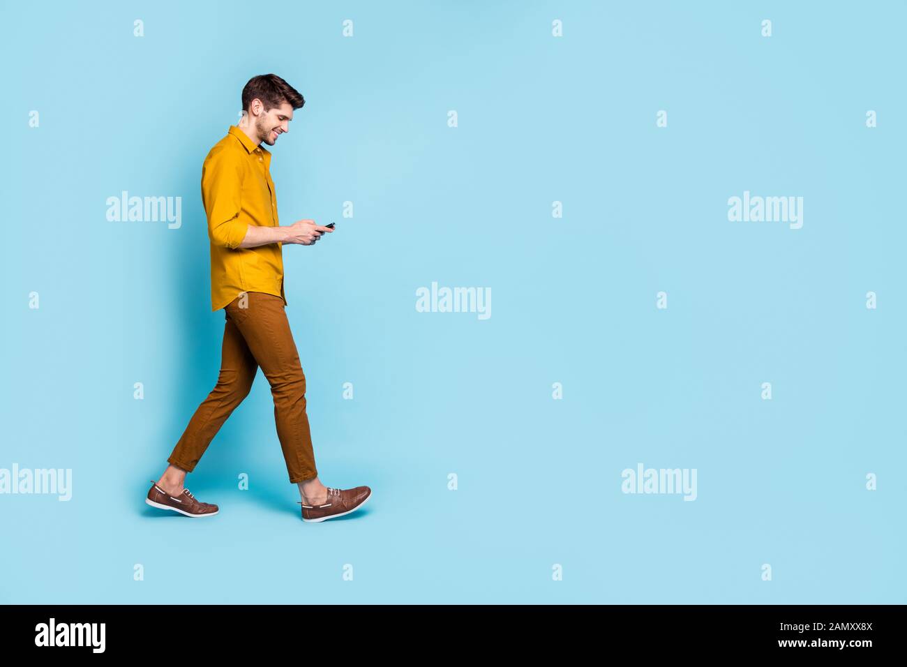 Photo of smiling toothy man wearing pants trousers footwear holding ...