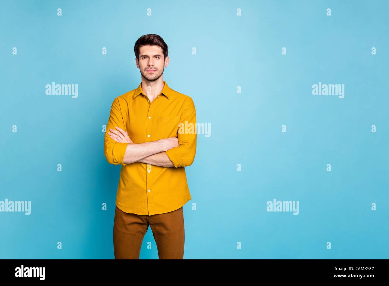 Photo of strict serious man with arms crossed looking at you intently ...
