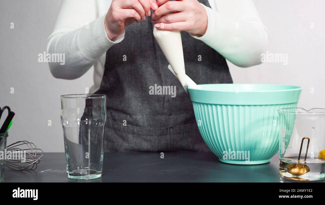 Step by step. Pouring royal icing into the piping bag to decorate sugar ...
