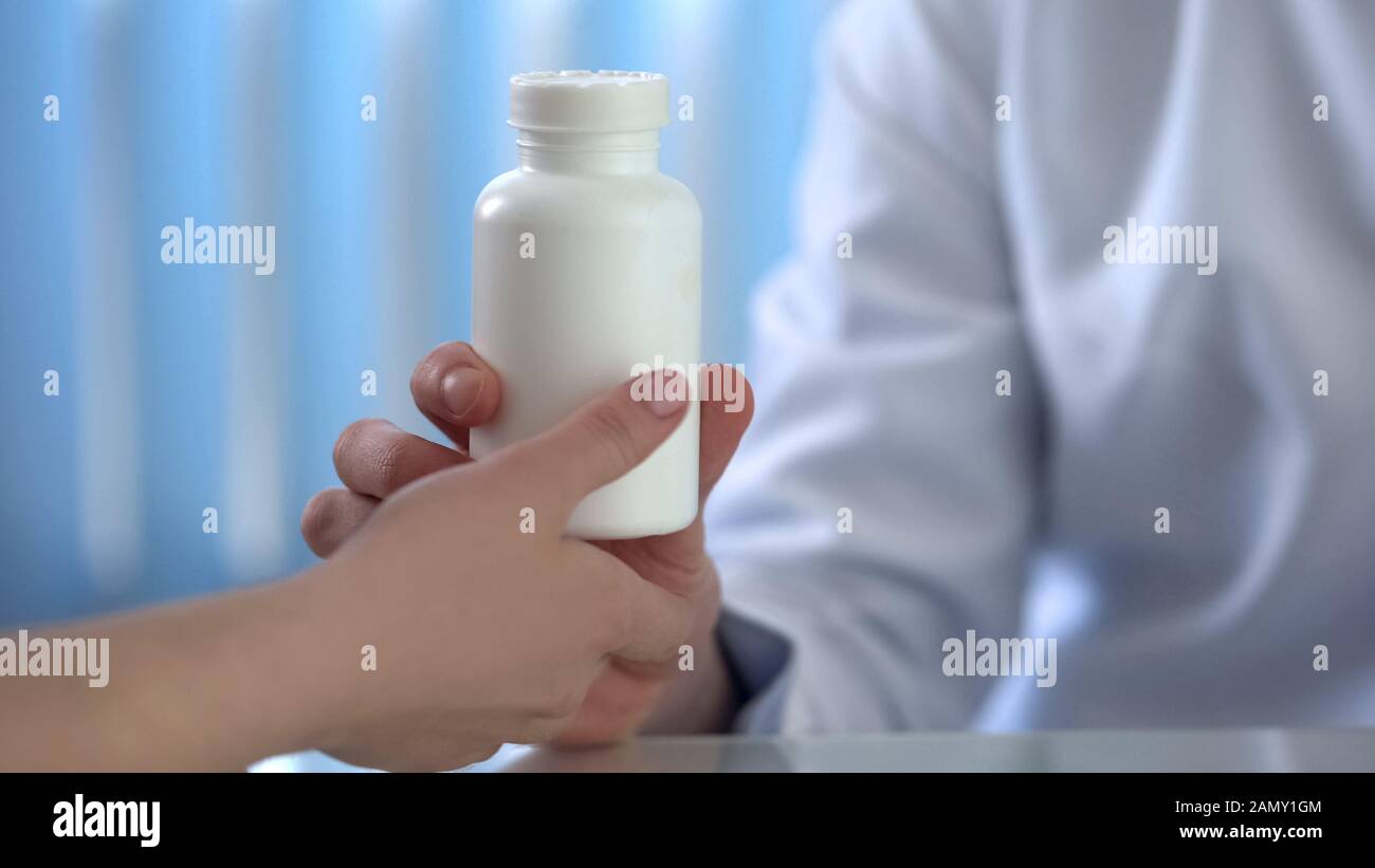 Doctor giving drugs to ill female patient at hospital, woman health ...