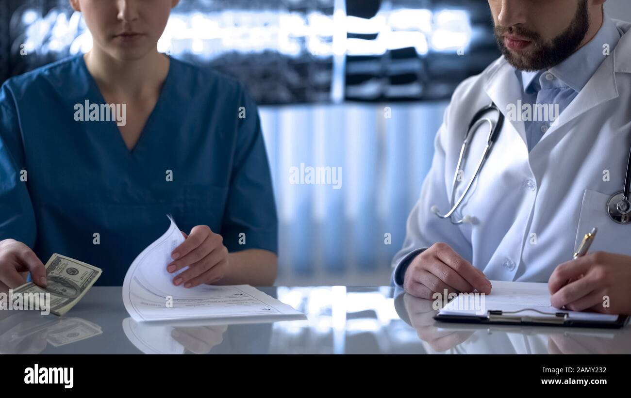 Female doctor giving bribe to head physician, dishonest people ...