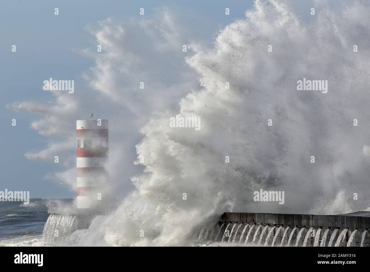 Big wave splash against pier and beacon Stock Photo - Alamy