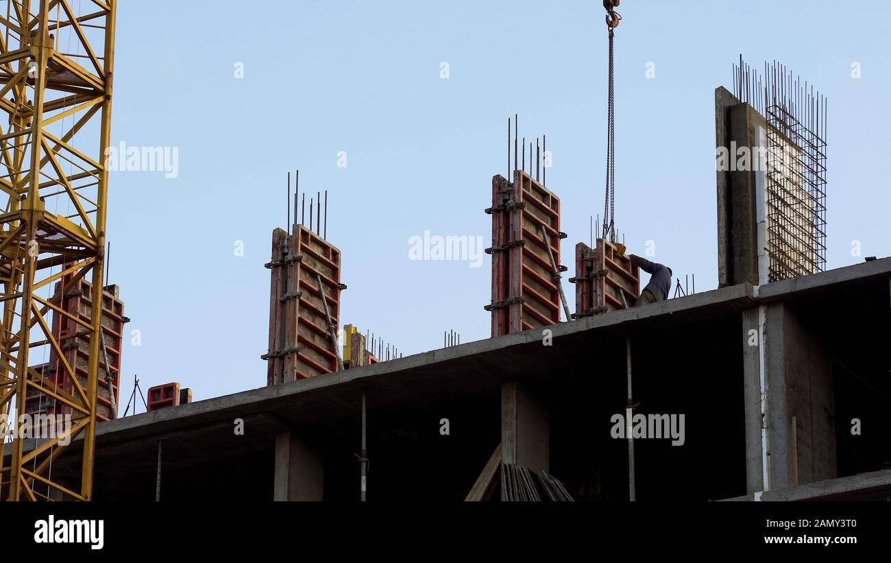 Building site shot workers installing concrete walls housing ...