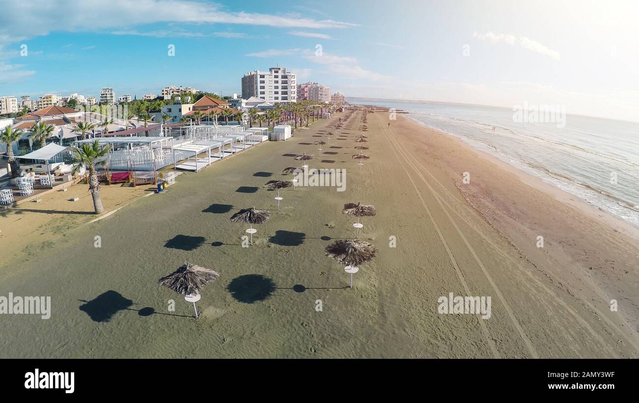Aerial panoramic view of beach in Larnaca city and straw parasols ...
