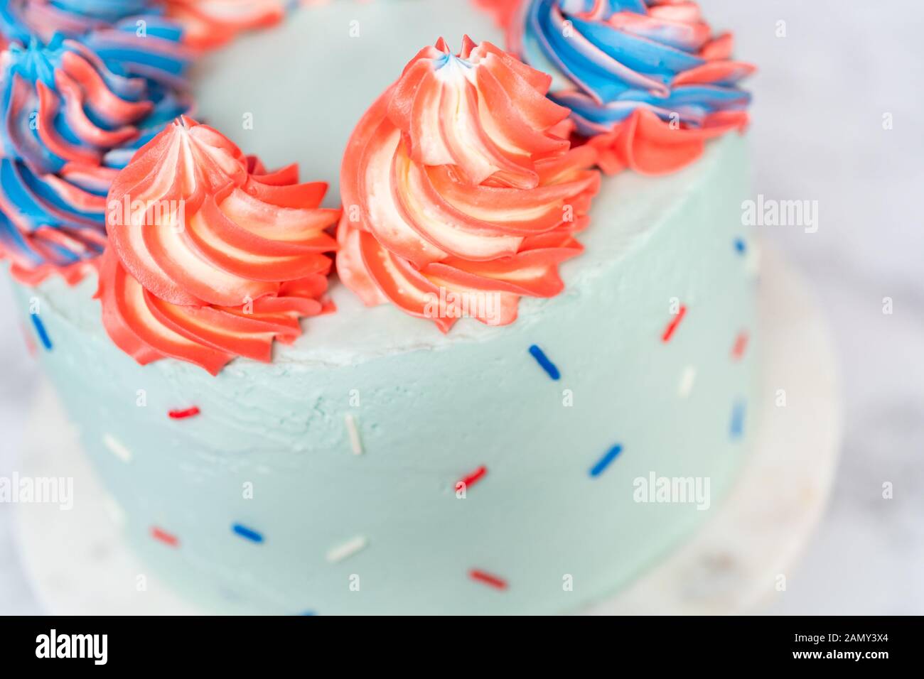 Red, white, and blue round vanilla cake with buttercream frosting for ...