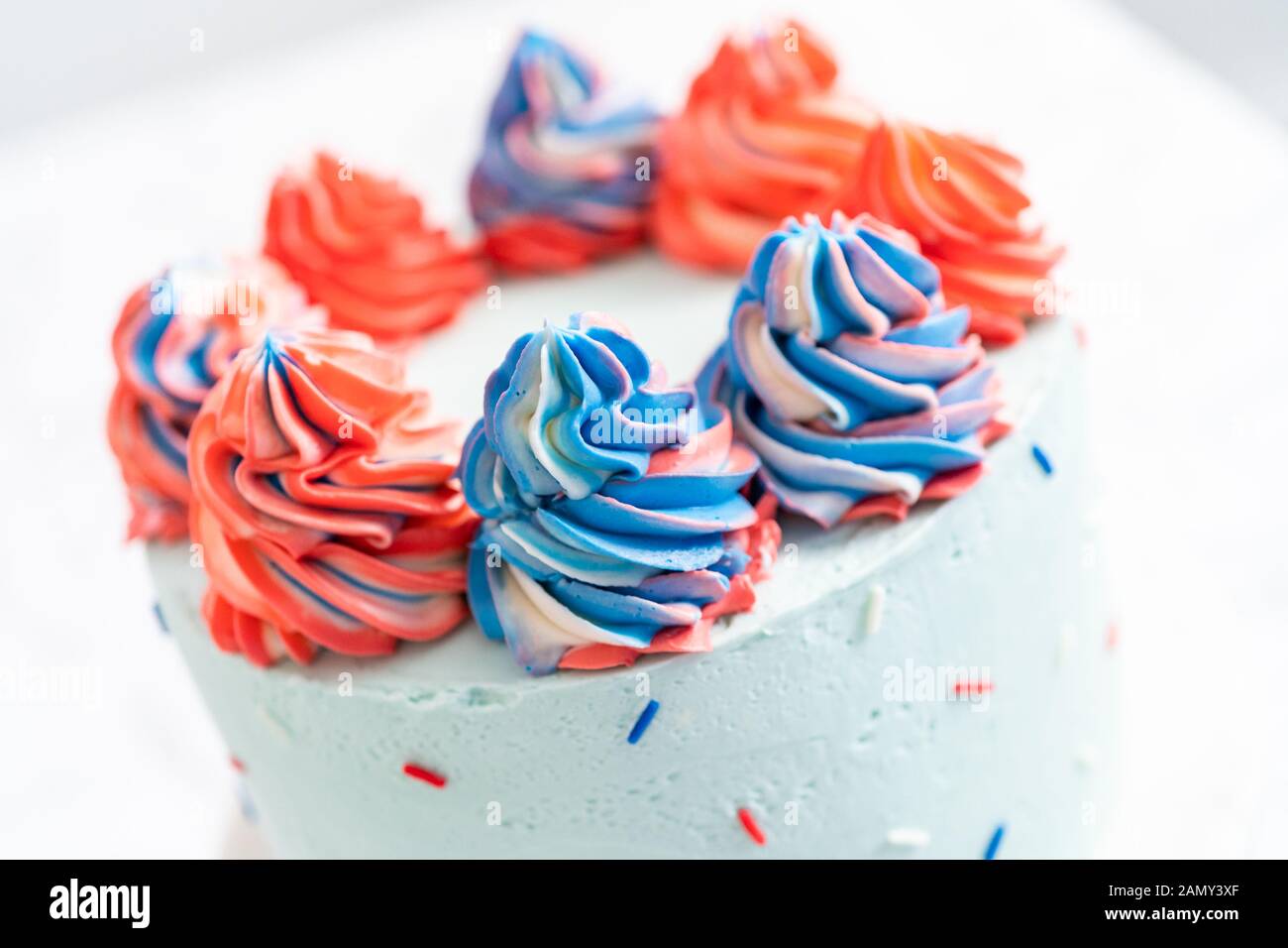 Red, white, and blue round vanilla cake with buttercream frosting for ...