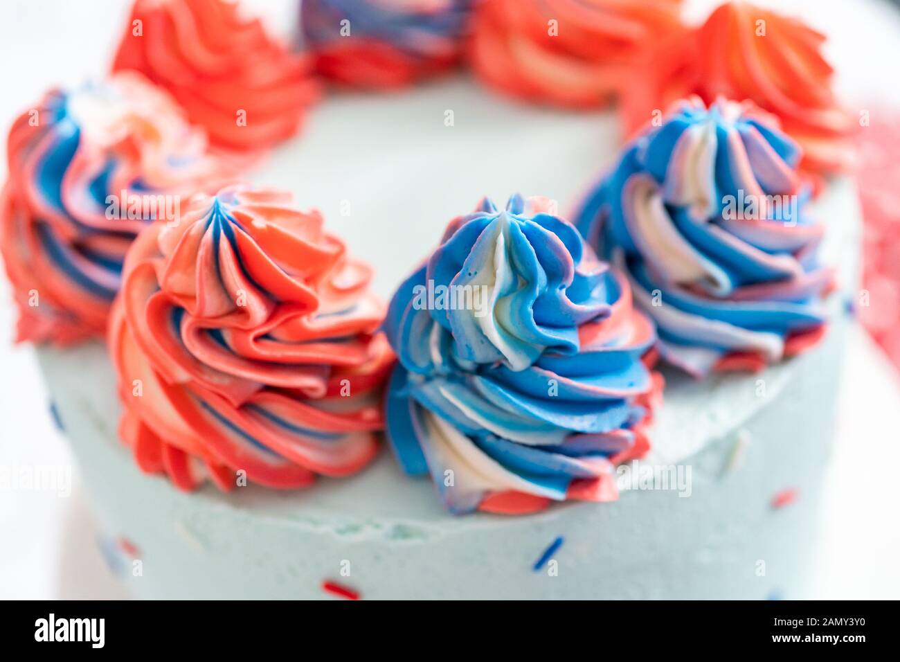 Red, white, and blue round vanilla cake with buttercream frosting for ...