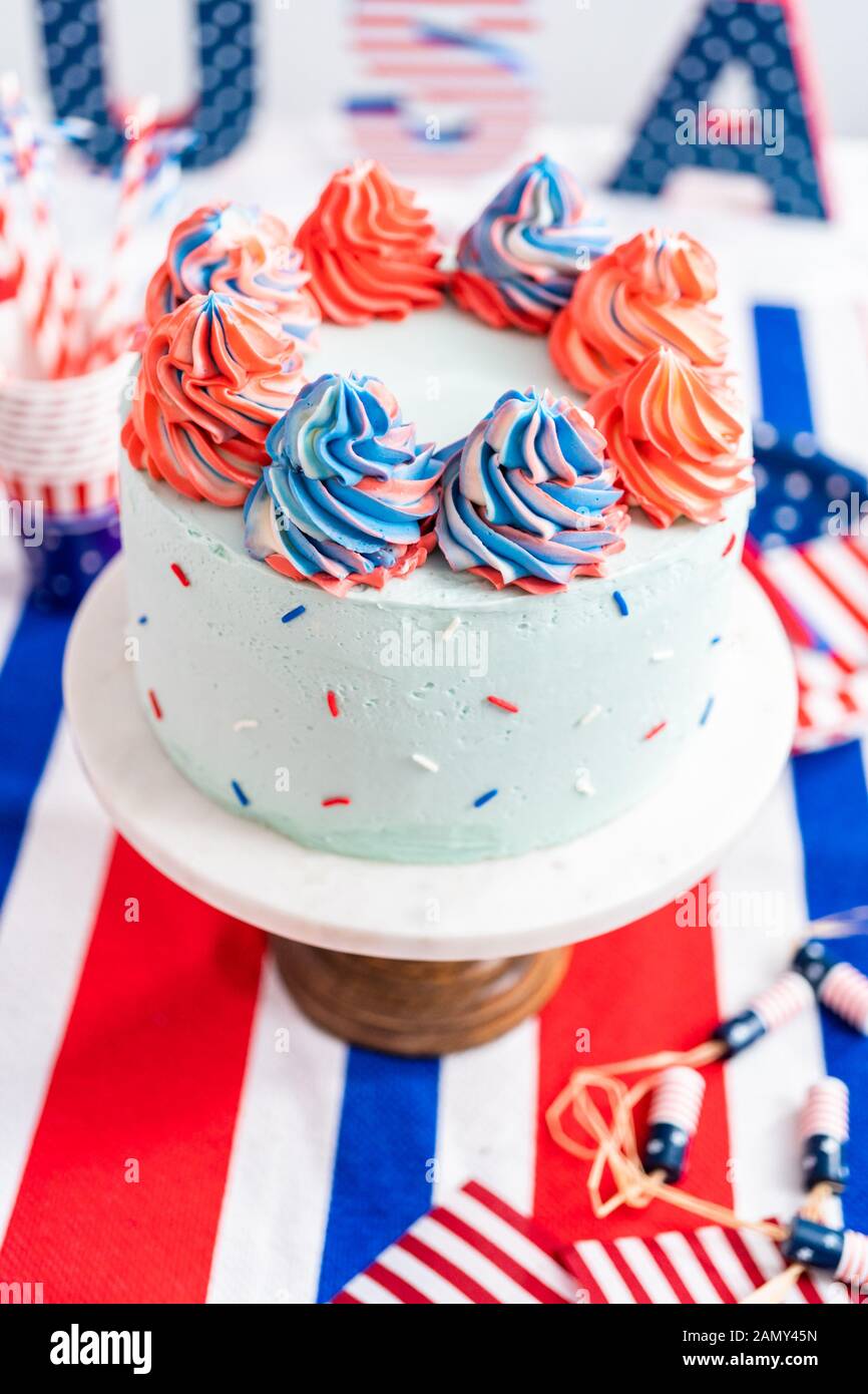 Red, white, and blue round vanilla cake with buttercream frosting for ...
