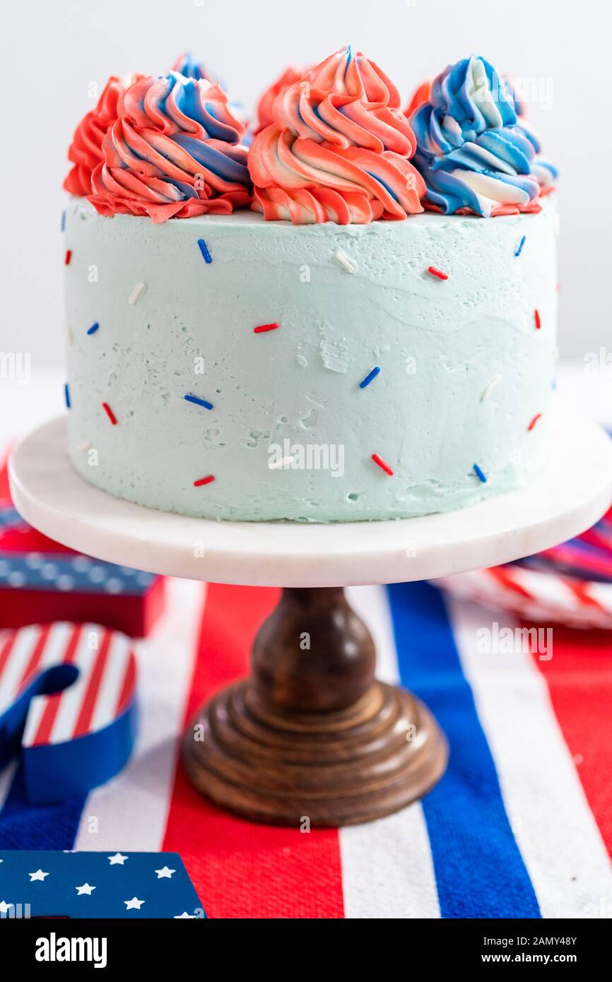 Red, white, and blue round vanilla cake with buttercream frosting for ...