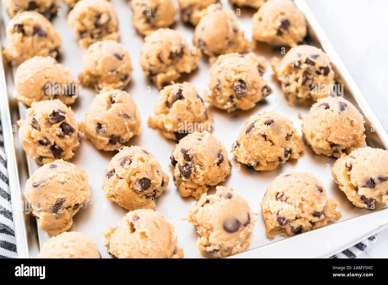 Homemade chocolate chip cookies dough scoops on a baking sheet Stock ...